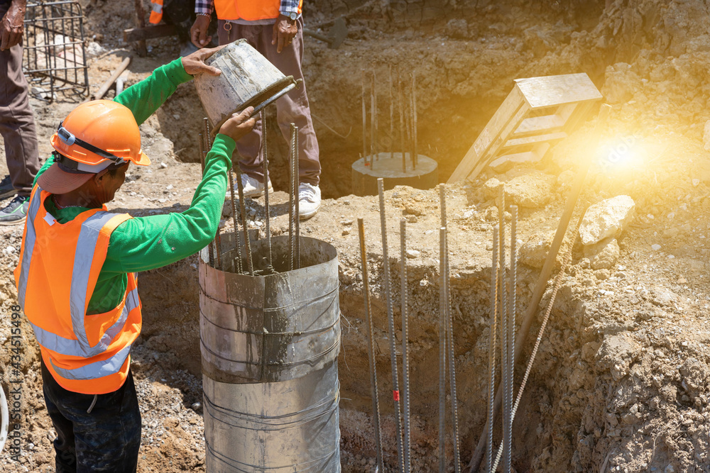 Construction workers pouring into the structural column formwork. Stock ...