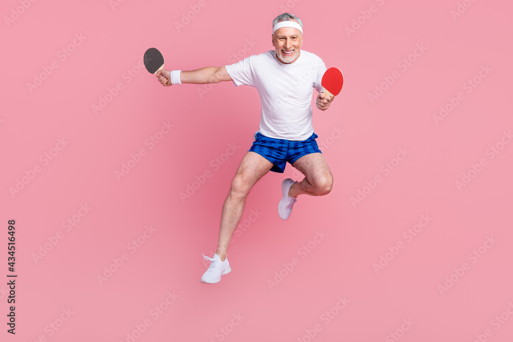 Full length body size photo senior man jumping up playing ping pong ...