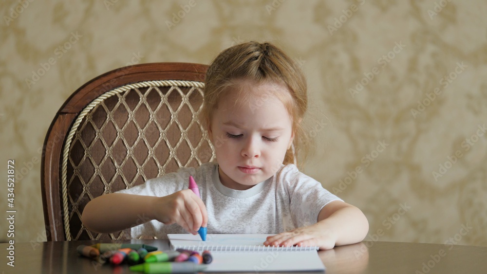 Funny little asian kid drawing at home. Boy with curly hair using his ...