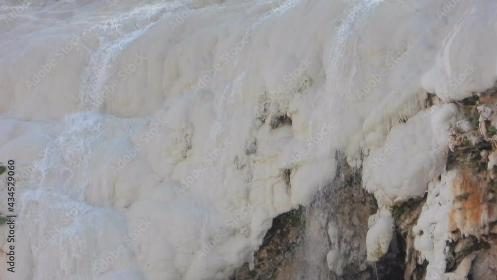 White travertine rock formed with the calcium carbonate mineral in the ...