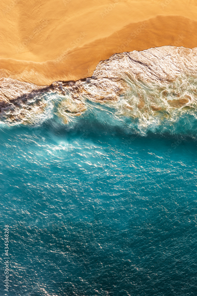 Peaceful bright beach, seaside, vertical view. Drone view of tropical blue ocean beach Nusa ...