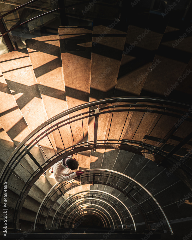 Man walking up the spiral stairs. Path to ascension and inner evolution ...
