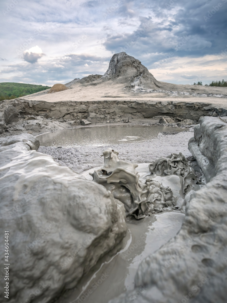 A mud volcano or mud dome is a landform created by the eruption of mud ...