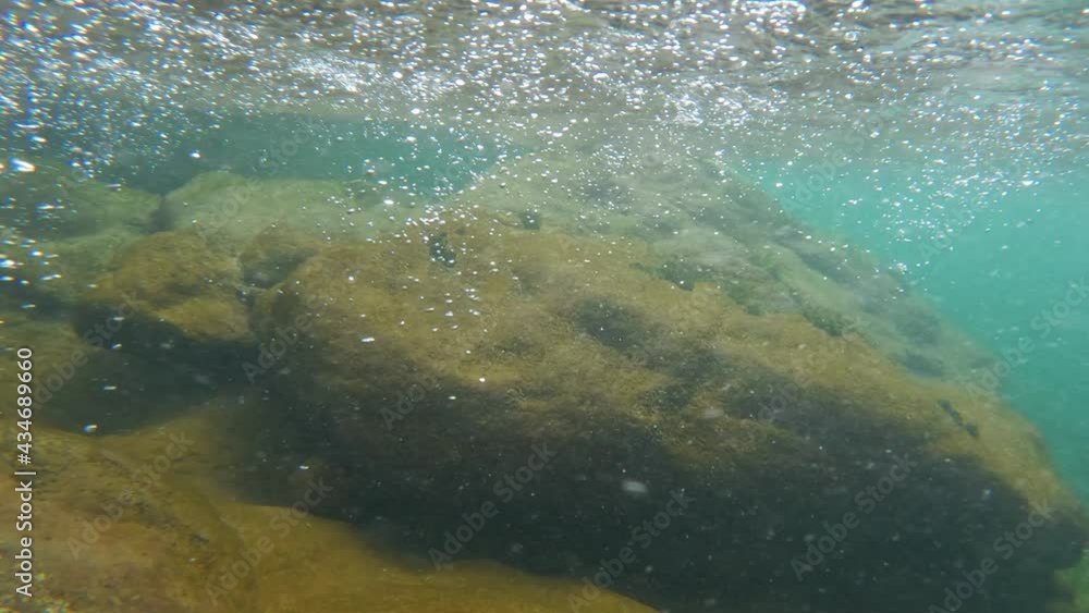 Water churned boils and bubbles underwater of fast flowing waters of ...