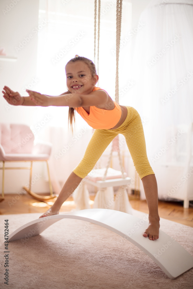 Little girl doing a workout in the bedroom at home. Stock Photo | Adobe ...