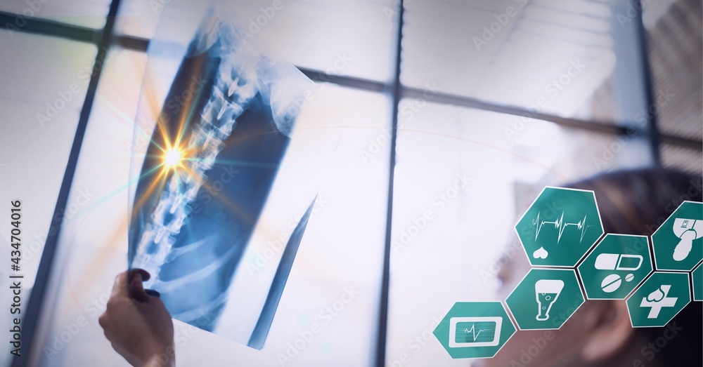 Spot of light and multiple medical icons against female doctor ...