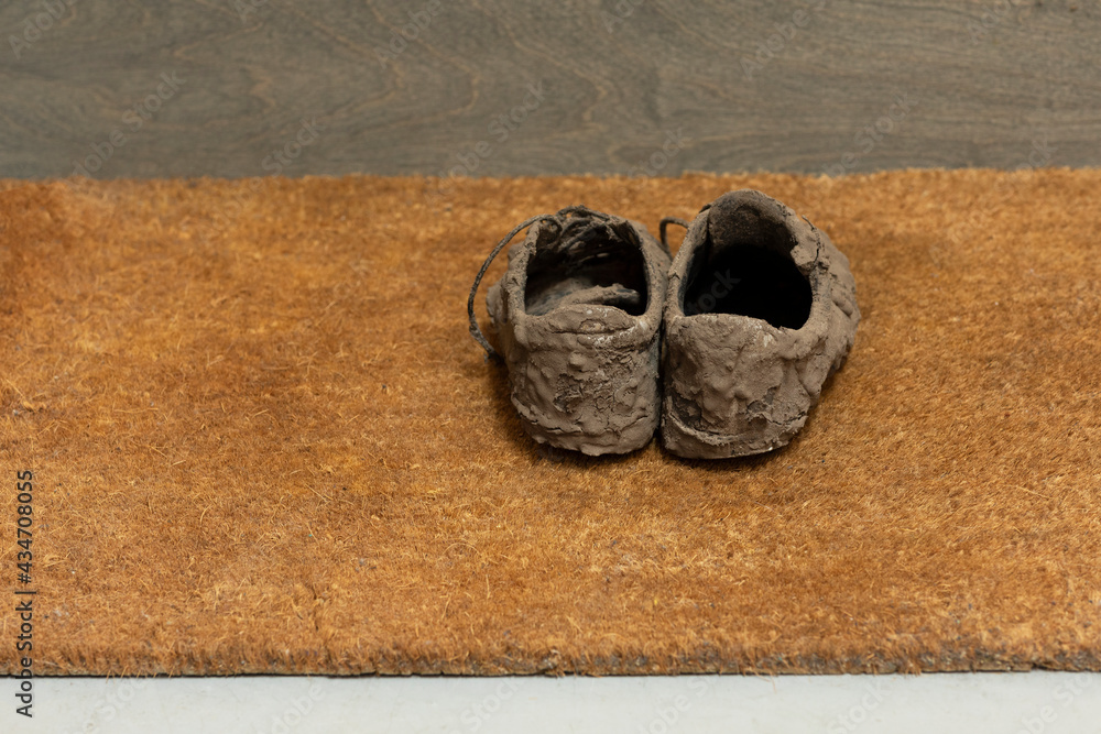 Dirty dried muddy and messy sneaker shoes totally covered with mud ...