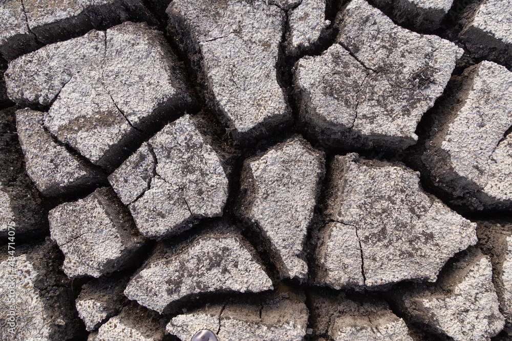 Beautiful wide deep cracks in the ground closeup background. Selective ...