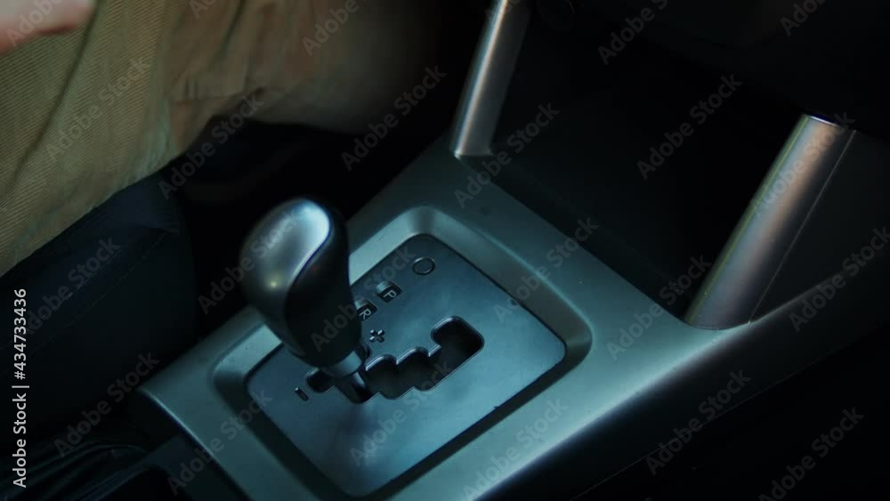 Stockvideon Adult man switching gear lever automatic transmission of a ...