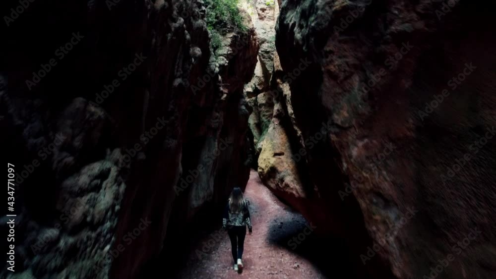Cave exploration, exploring a cavern. Young woman explorer walks ...