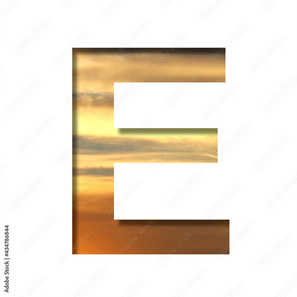 Font on the sunset sky. The letter E cut out of paper on the background ...