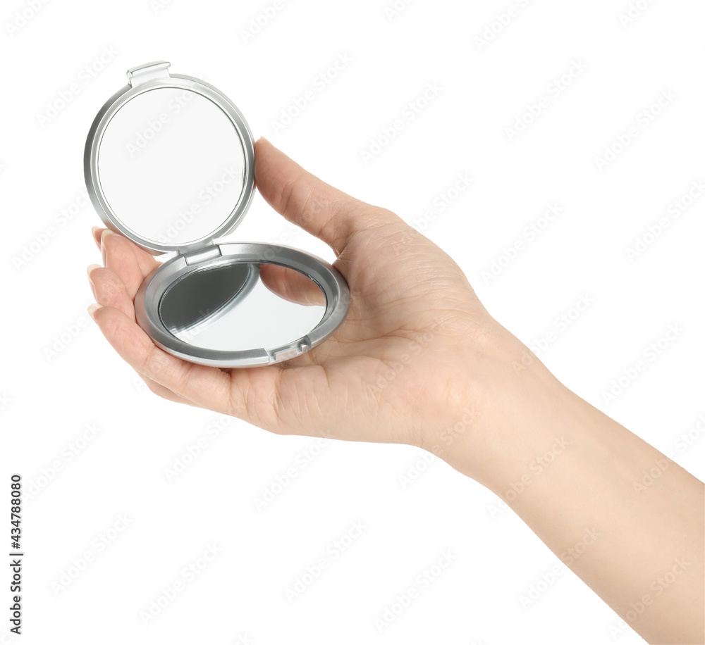 Woman holding grey cosmetic pocket mirror on white background, closeup ...