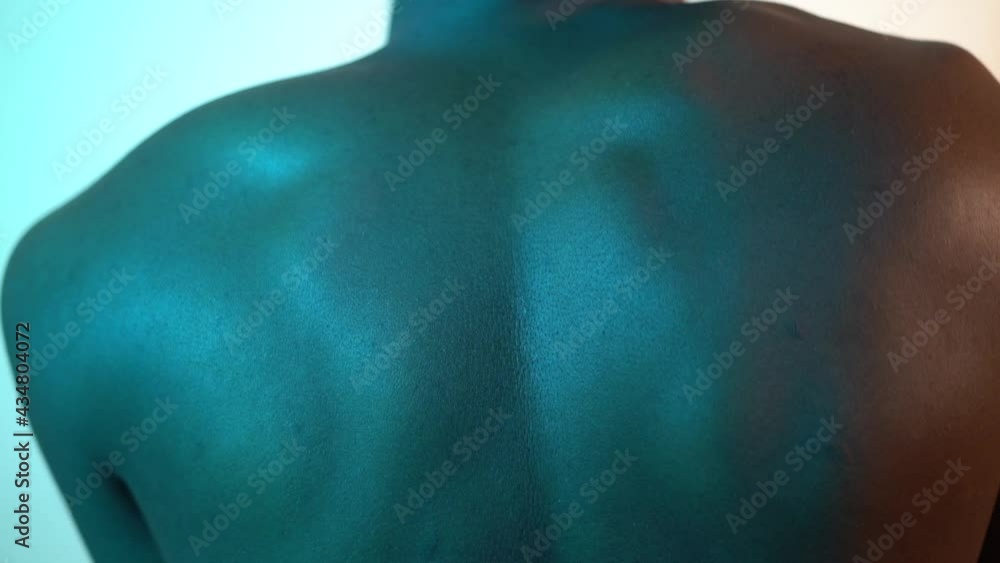 Black African male flexing his back muscle to the camera. Muscular male ...