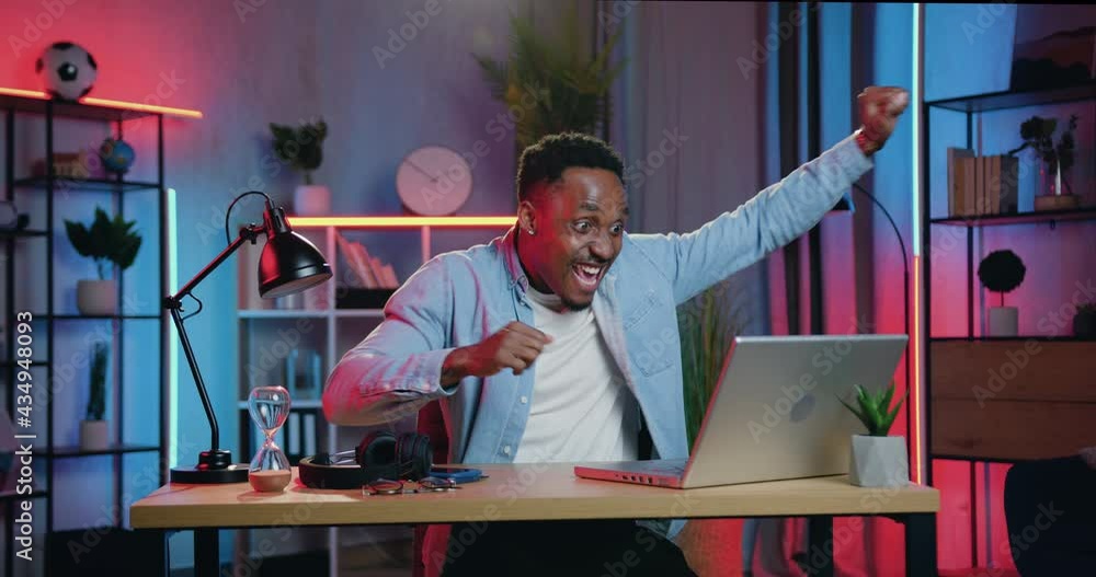 Good-looking cheerful excited young african american sitting at the ...