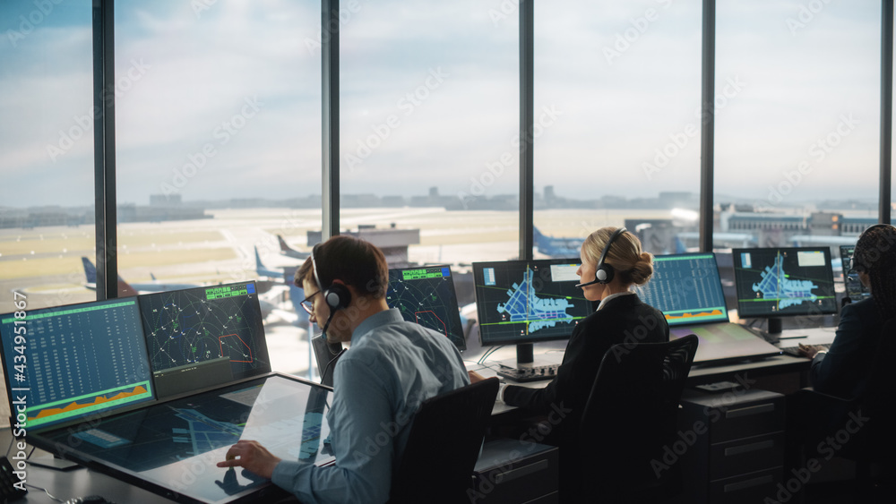 Diverse Air Traffic Control Team Working in a Modern Airport Tower ...