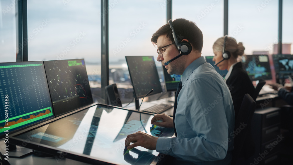 Male Air Traffic Controller with Headset Talk on a Call in Airport ...