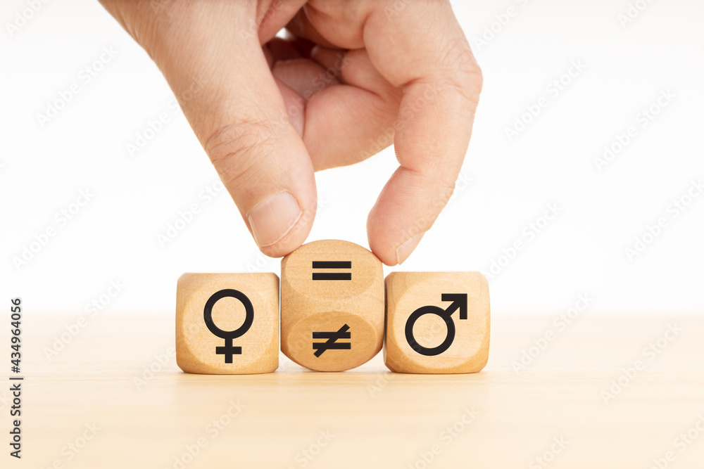 Gender equality concept. Hand turns a wooden block and changes a ...