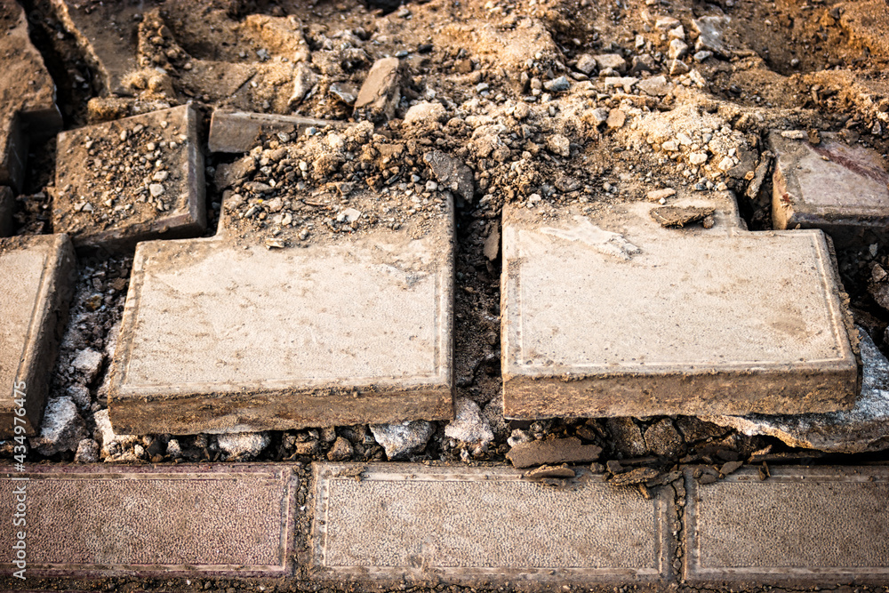 Footwalk repair. Broken pavements paving slabs on sidewalk near trench ...