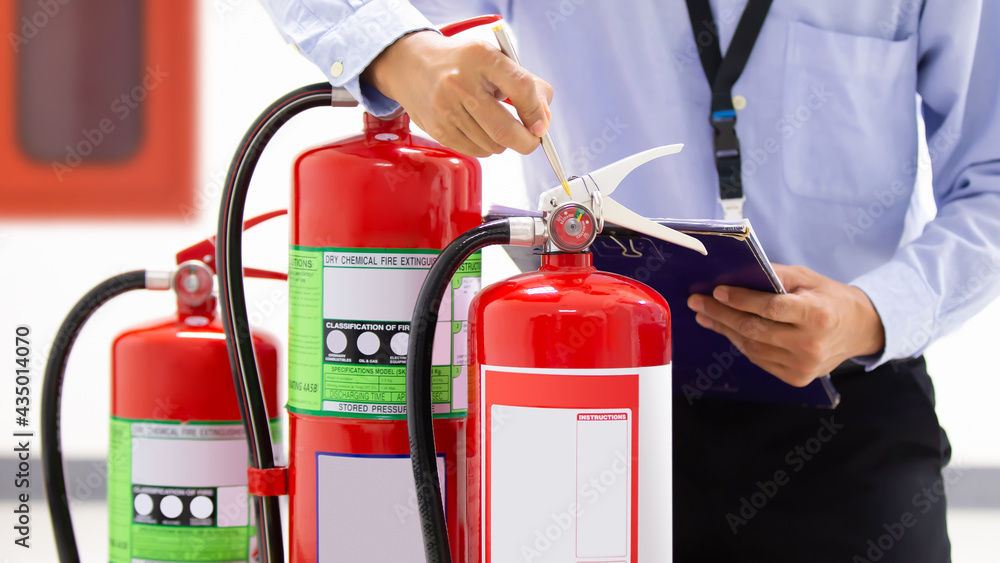 Fire extinguisher, Firefighter checking pressure gauge level of fire ...