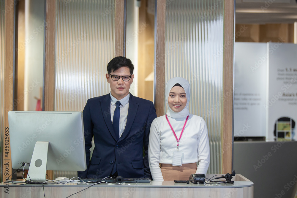 young Asian reception team hotel front desk welcoming . Asian reception ...