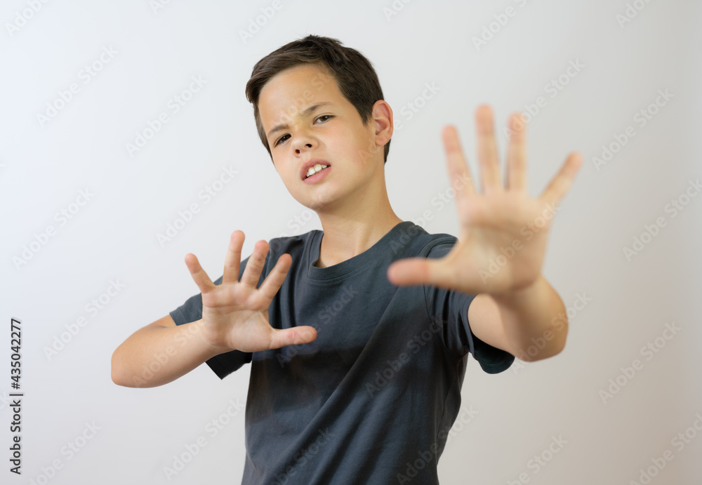 Little boy caucasian kid wearing casual clothes moving away hands palms ...
