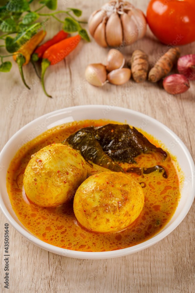 Gulai telur or eggs serve with curry sauce, Gulai Telur is traditional ...