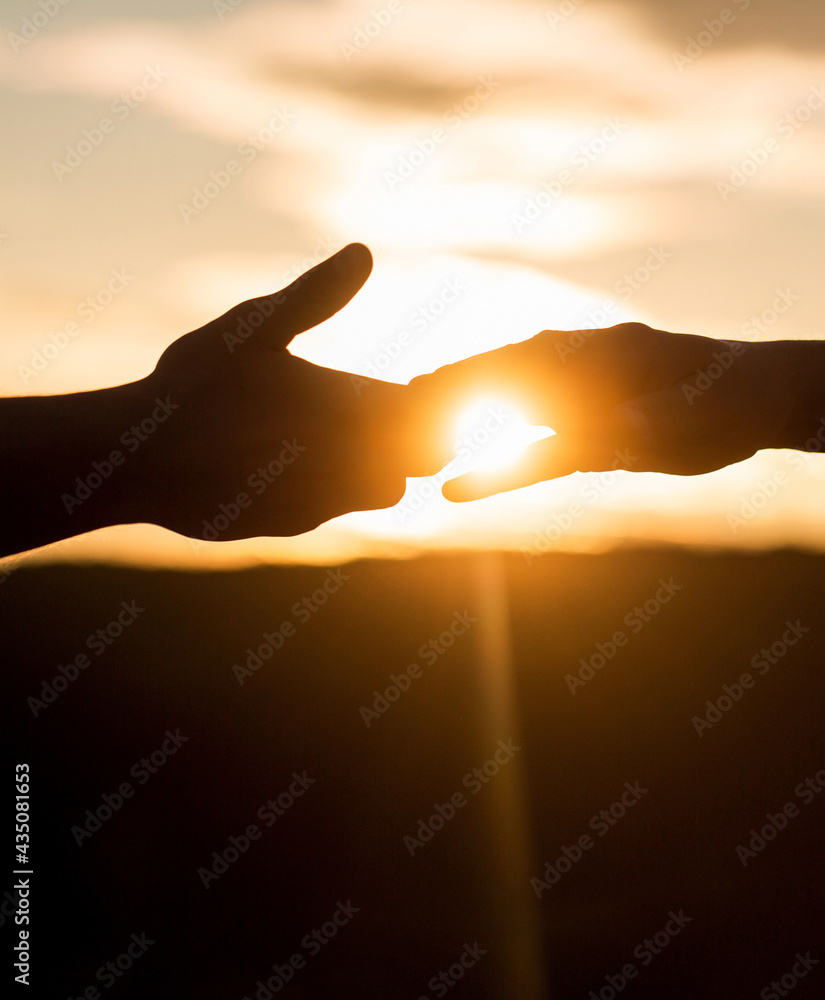 Two hands silhouette on sky background, connection or help concept. Outstretched hands ...