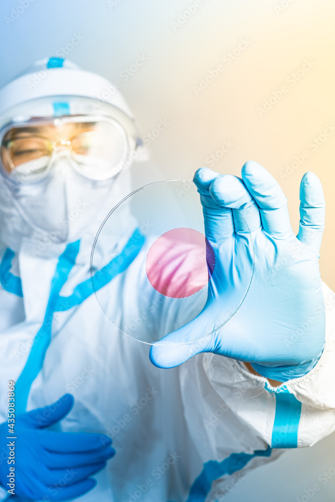 Vaccine researcher with protective clothing in the laboratory with ...