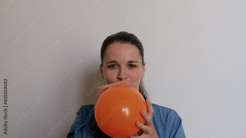 Girl prepares for holiday and inflates balloon and then lets it fly ...