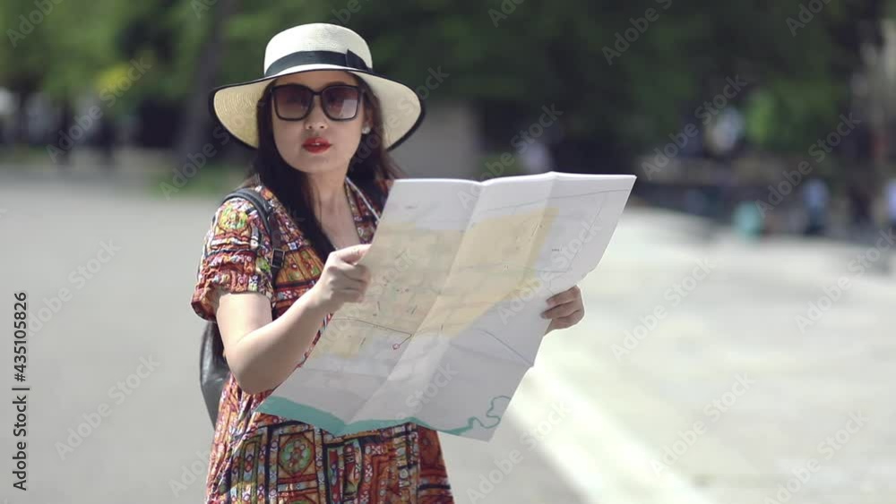 Using maps for travel concept, Young Asian women traveling and looking ...