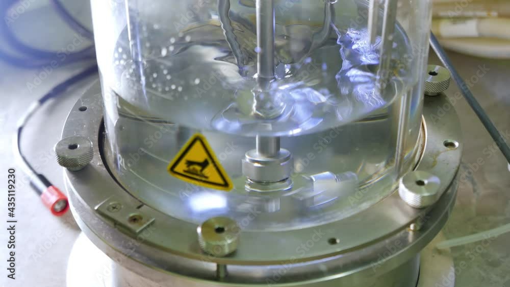 Liquid bioreactor, glass cylinder with mixing liquid inside. Science ...