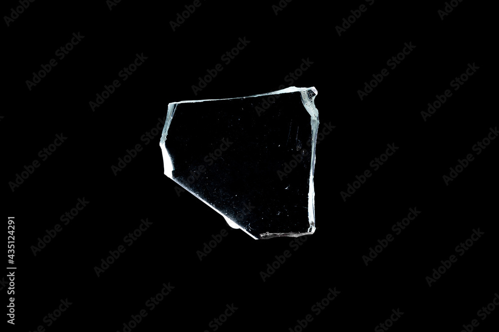 glass fragments in isolation on a black background. damaged window ...