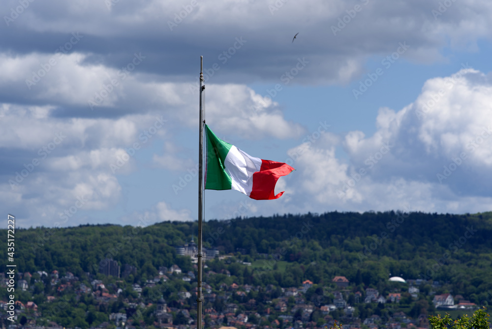 Italian flag at garden plot with City of Zurich in the background ...