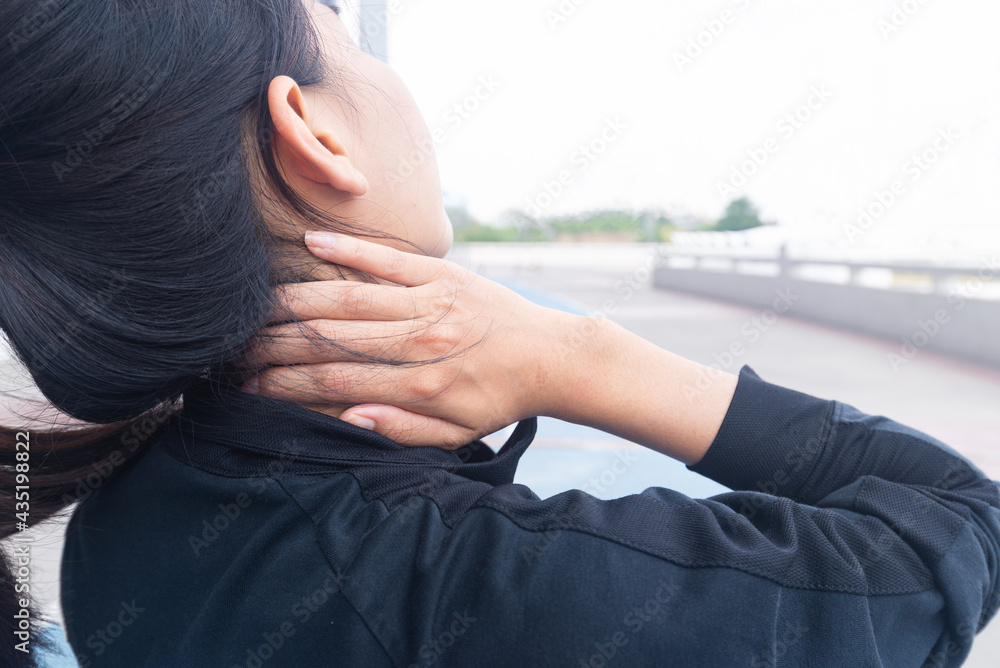 Woman athlete runner with Neck pain injury during training with hand ...