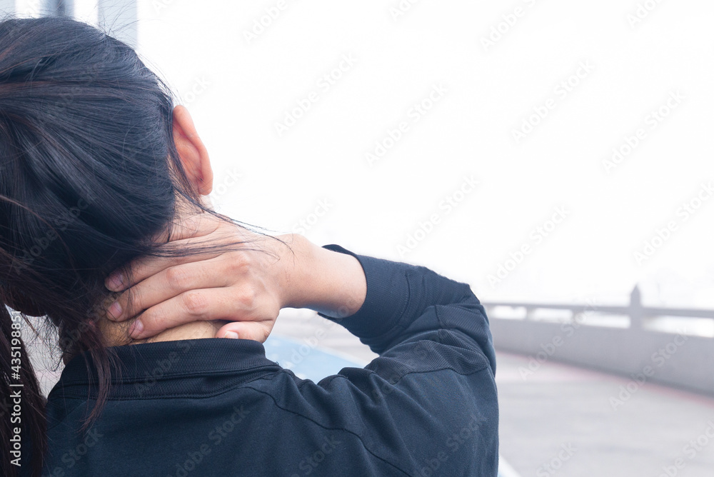 Woman athlete runner with Neck pain injury during training with hand ...