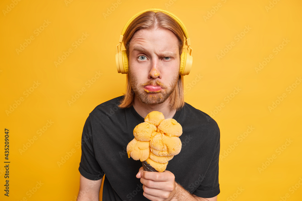 Displeased redhead man frowns face makes unhappy grimace raises ...