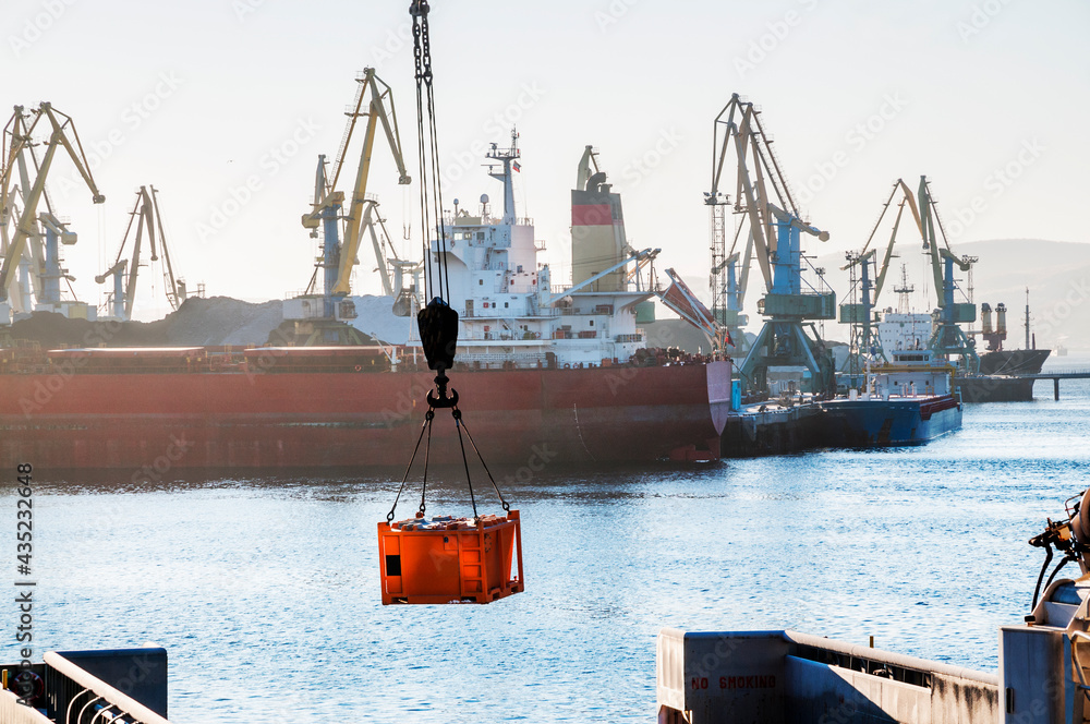 Loading cargo onto the deck of a supply vessel for servicing drilling ...