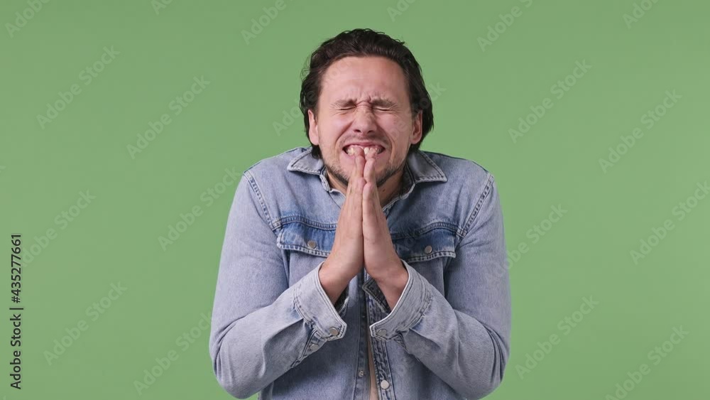 Pleading brunet blue eyed young man 20s years old wear denim shirt hold ...