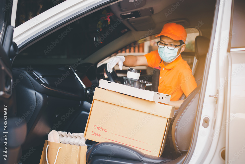 Delivery man employee checking list order online in car for customer ...