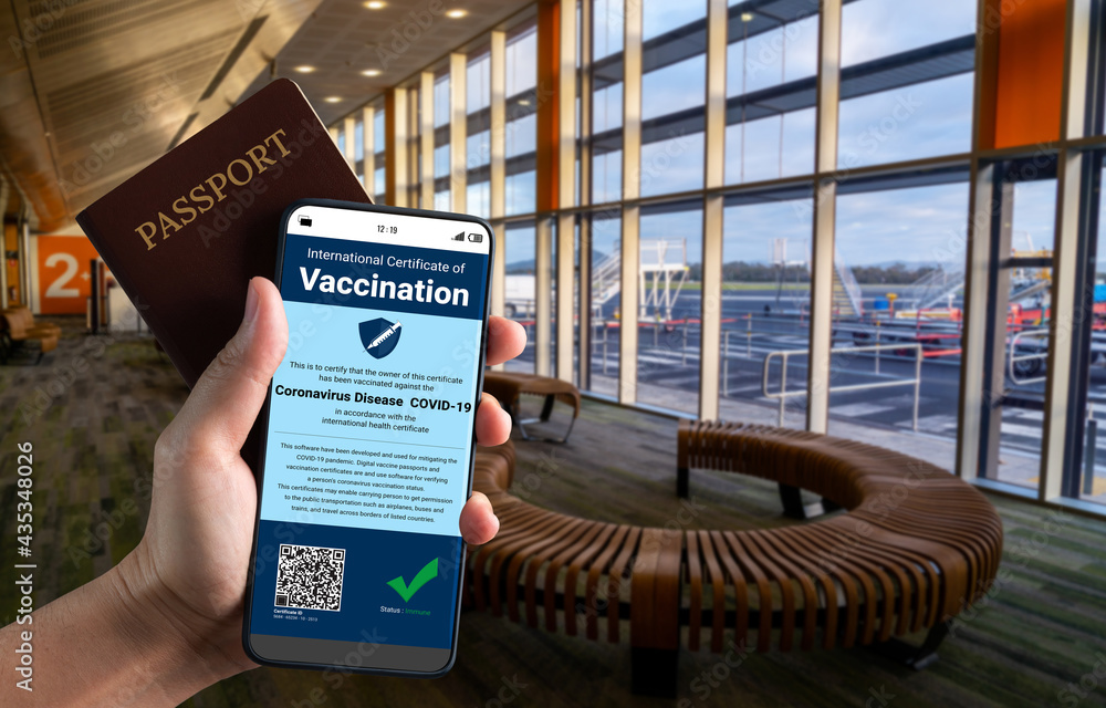 Traveler holds vaccine passport certificate to show COVID 19 ...