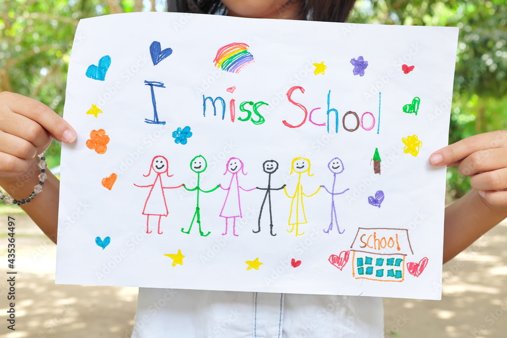 Child holding I miss School paper work drawing. Sadness in ...