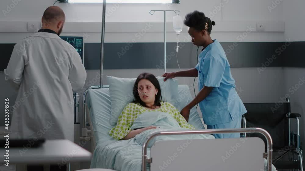 Asisstant with black skin arrange sick woman bed during sickness ...