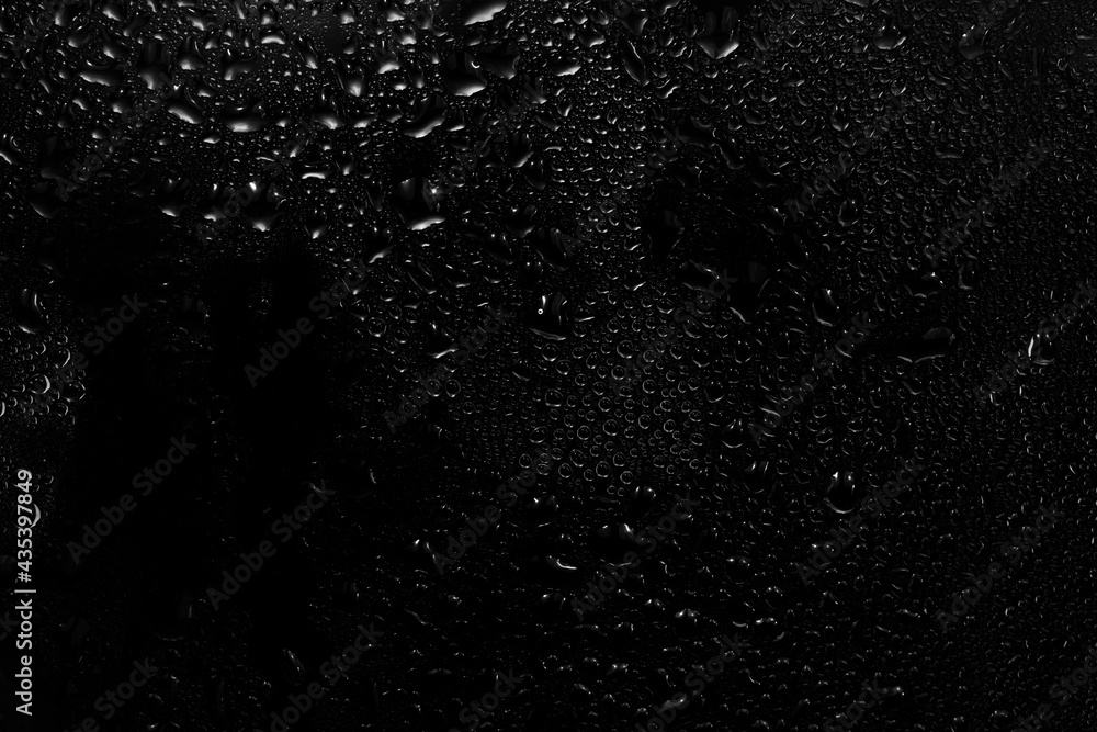 water drops on black background. abstract dew water droplets on a window glass for photo overlay ...