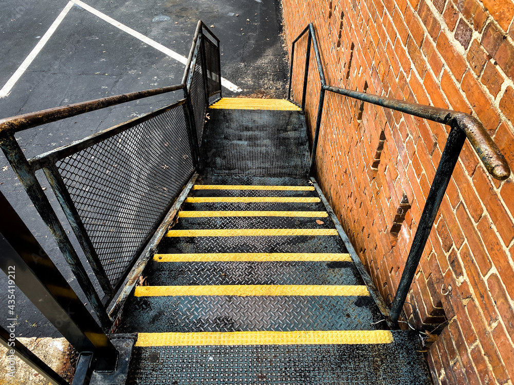industrial fire escape safety alley stairs steps with bright yellow ...