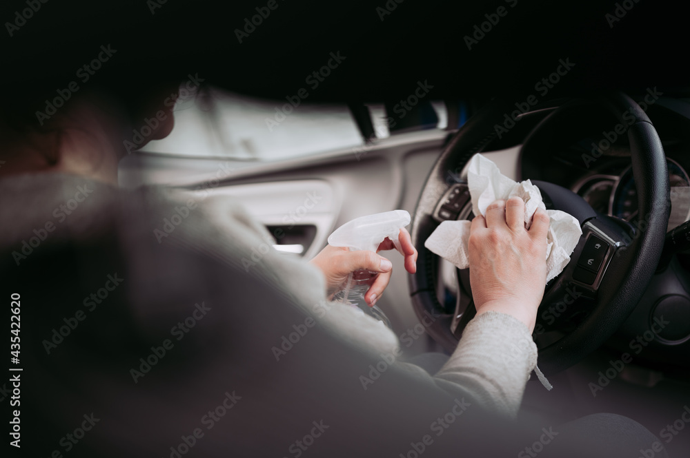 Female driver taking care of car interior hygiene. Woman's hands ...