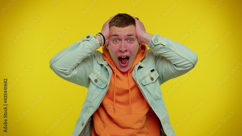 Teenager student boy scared fearful, covering ears with hands, open ...