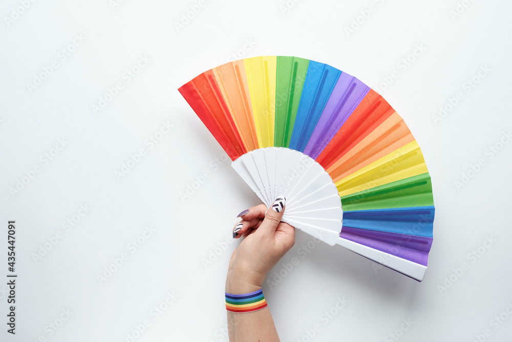 LGBTQ community pride. Hand holds. rainbow fan. Ribbon with rainbow ...