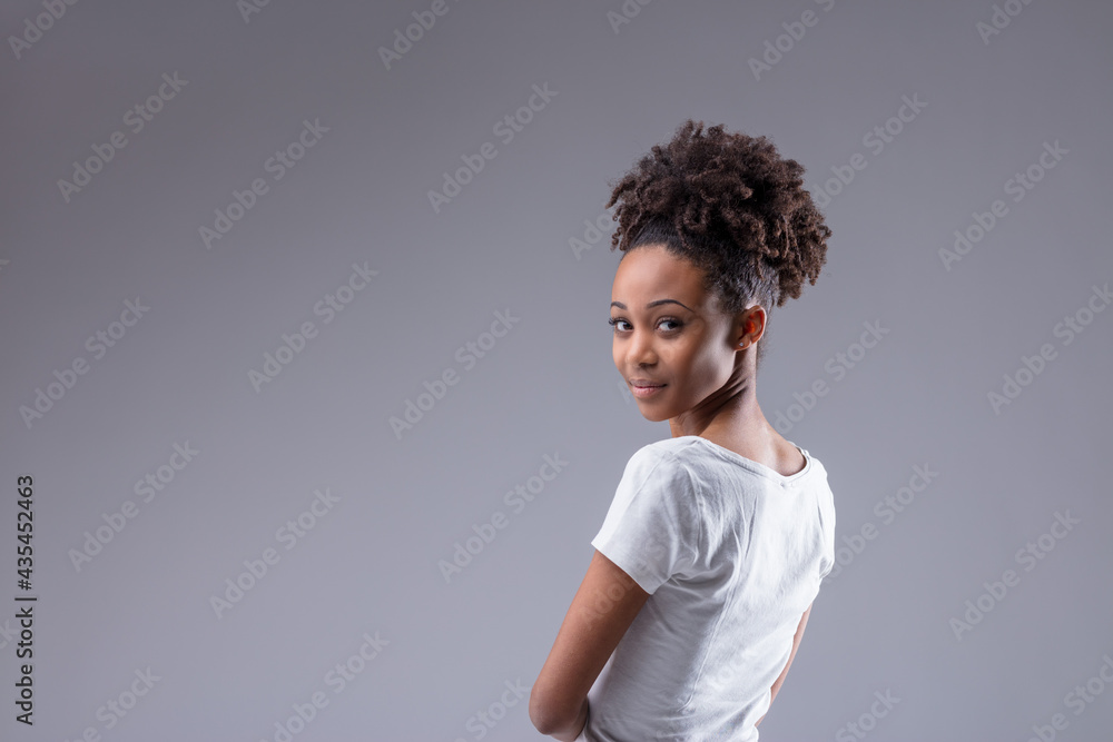 Young Black woman looking back at camera over her shoulder Stock Photo ...