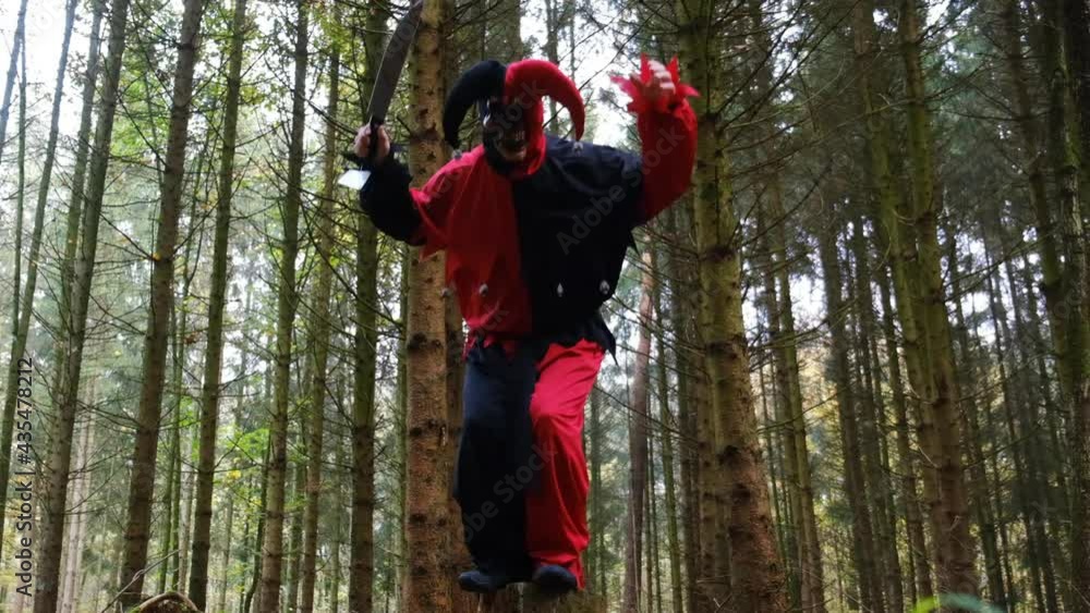 Halloween. Scary jester attack with a knife.Aggressive evil clown in ...