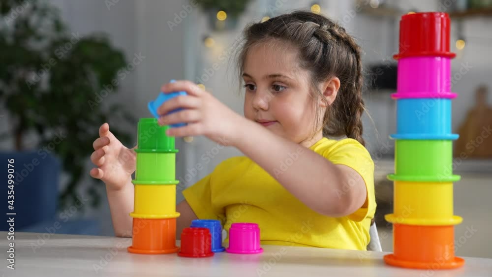 Preschool kid play with color blocks. Happy girl educational games ...